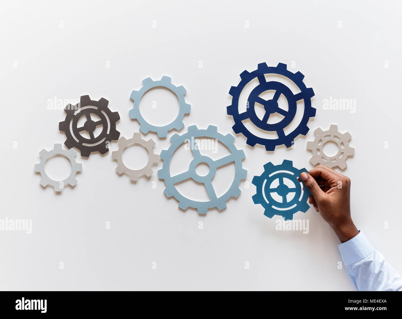 Hand with support gears isolated on white background Stock Photo - Alamy