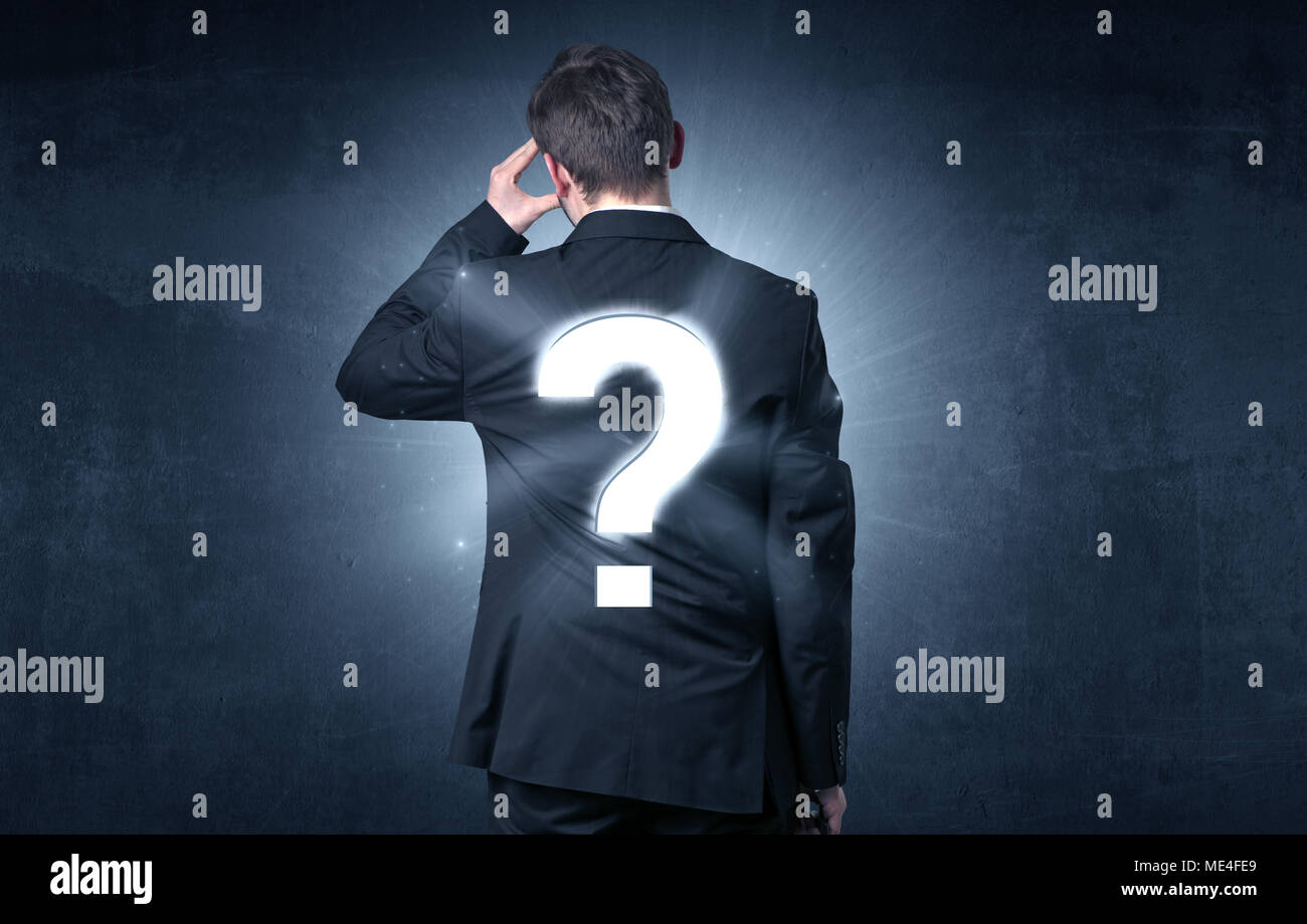Businessman standing and thinking about questions Stock Photo - Alamy