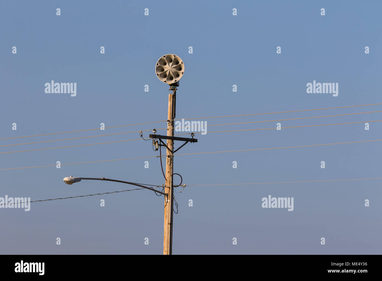 a light, power lines and civil defense on a pole Stock Photo - Alamy