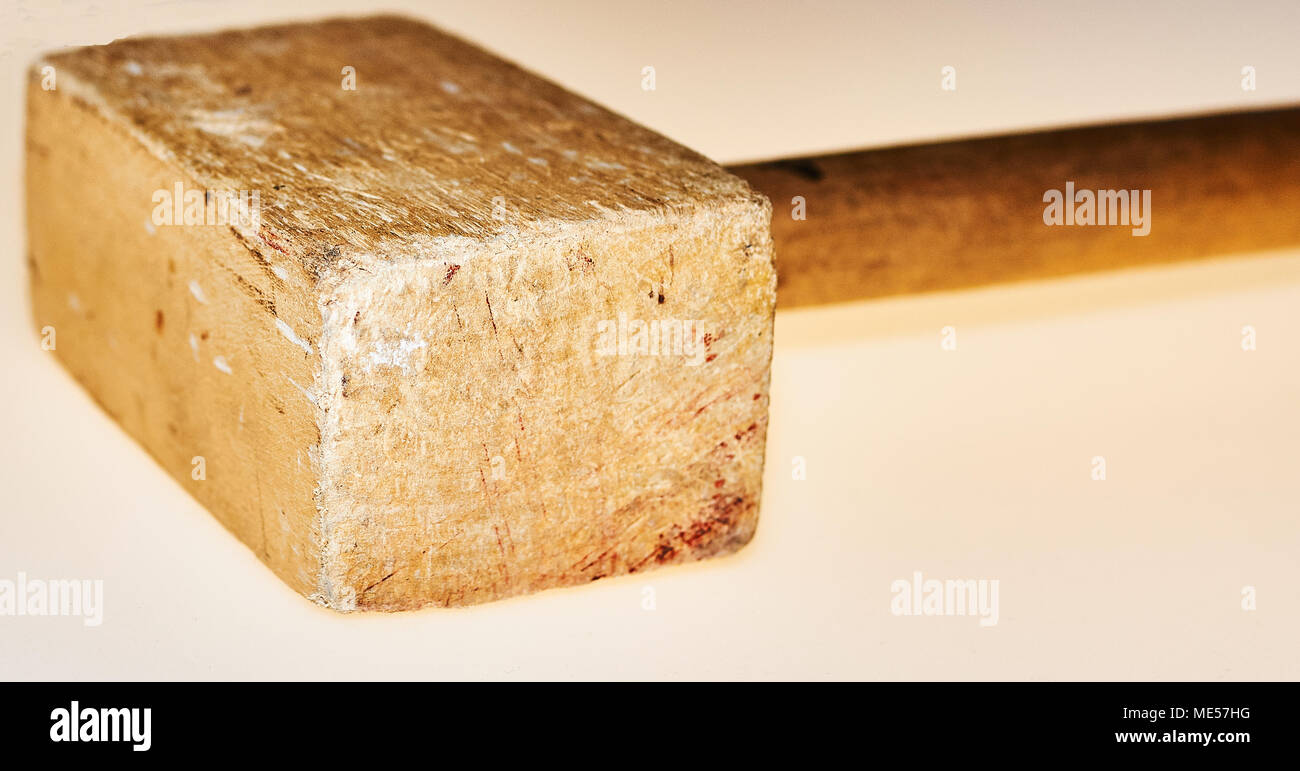 A hammer from a tree lies on an isolated background. The hammer was ...