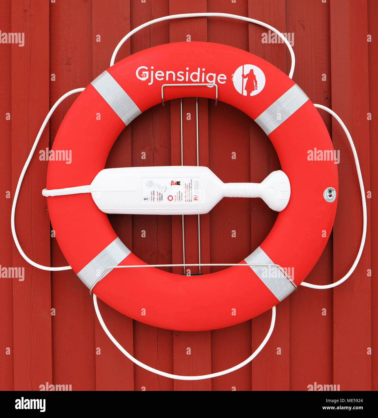 Red life buoy on a wooden autentically red painted norwegian wall with ...
