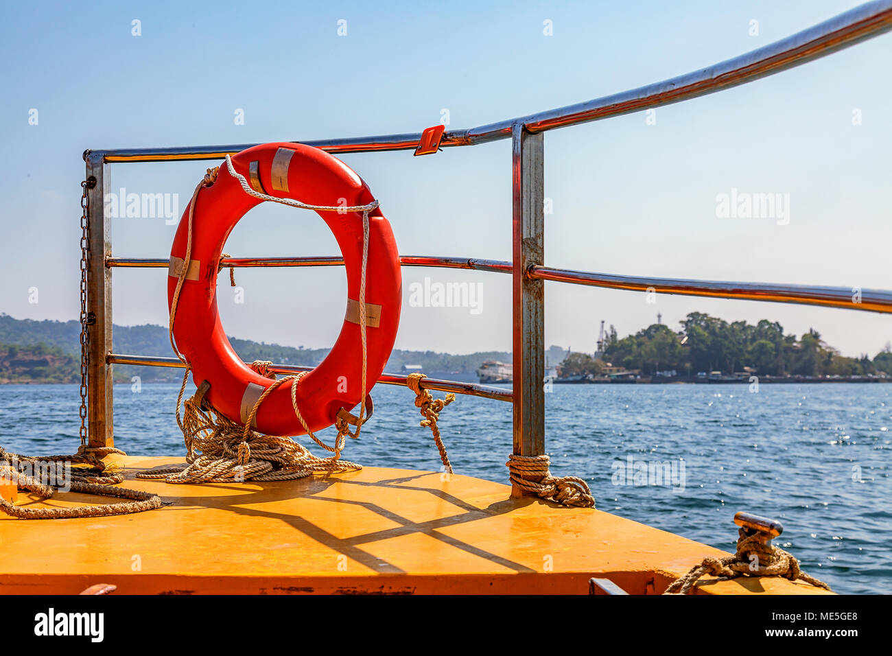 Lifebuoy railings at the front end of a tourist speed boat with view of ...