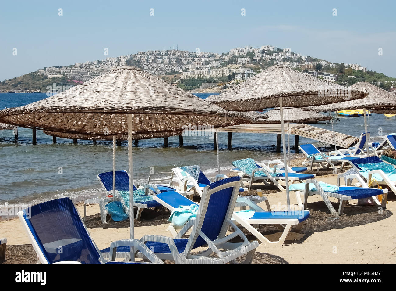 Umbrellas and blue sunbeds on the beach of the popular resort of ...