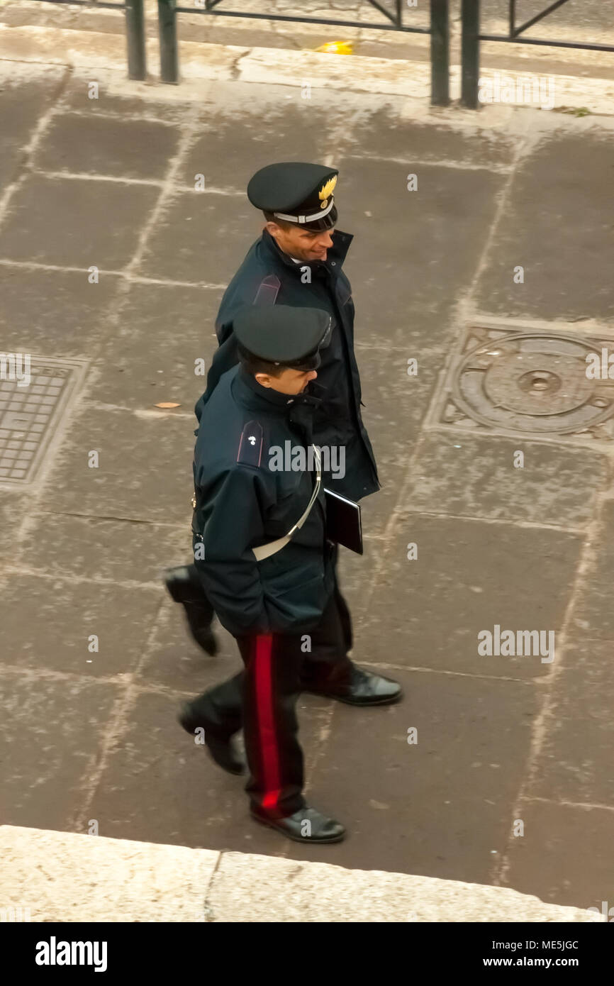 Rome, Italy - February 22, 2015: On a street next to the Colosseum walk ...