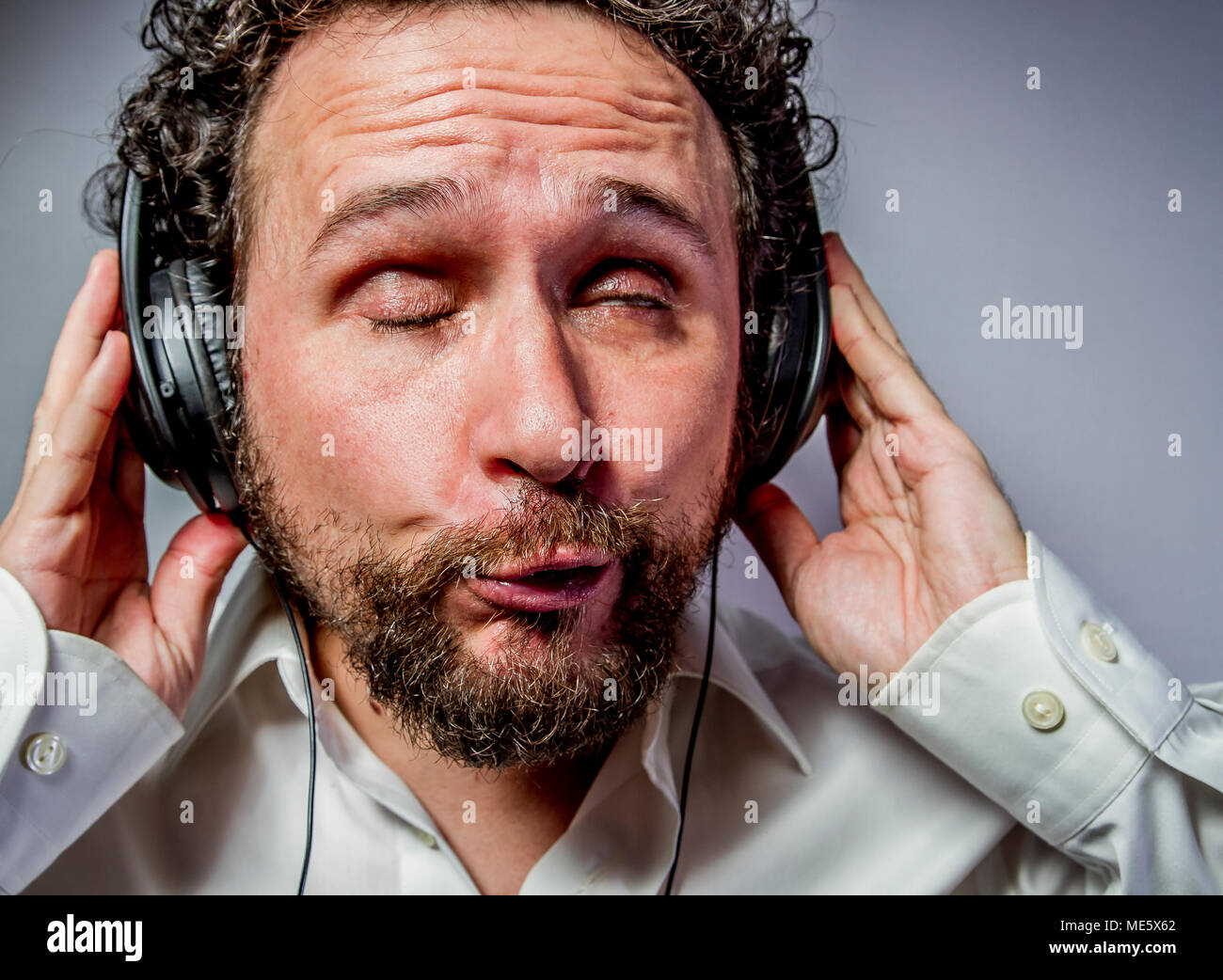 enjoy the music, man with intense expression, white shirt Stock Photo ...