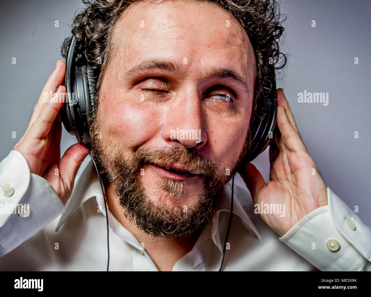 enjoy the music, man with intense expression, white shirt Stock Photo ...