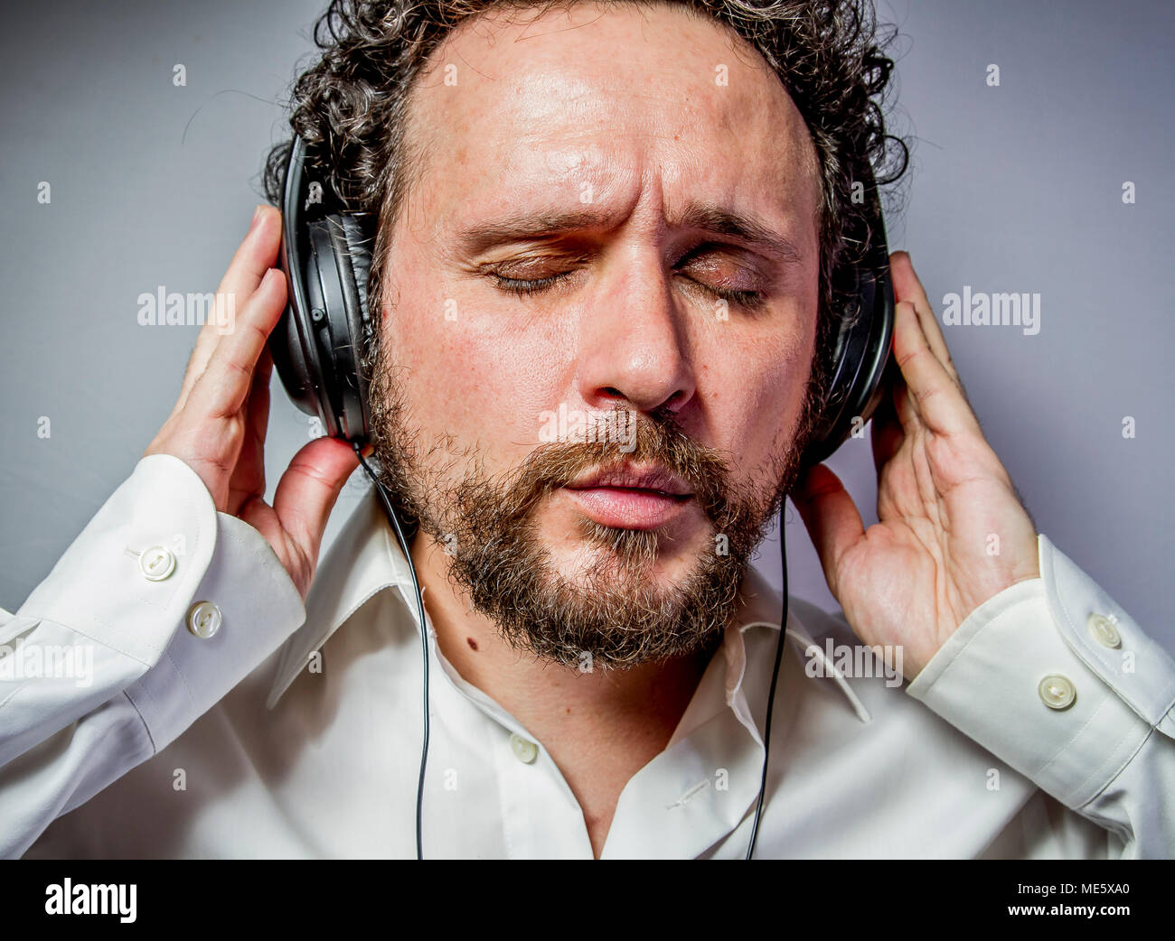 enjoy the music, man with intense expression, white shirt Stock Photo ...