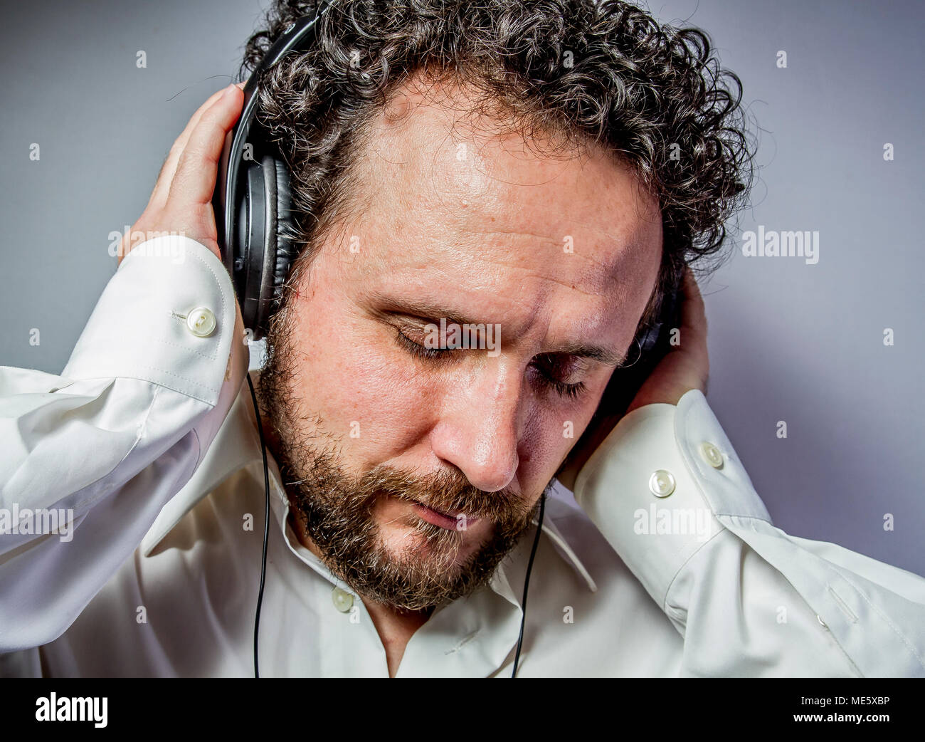 enjoy the music, man with intense expression, white shirt Stock Photo ...