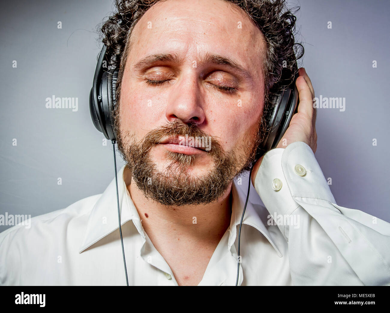 enjoy the music, man with intense expression, white shirt Stock Photo ...