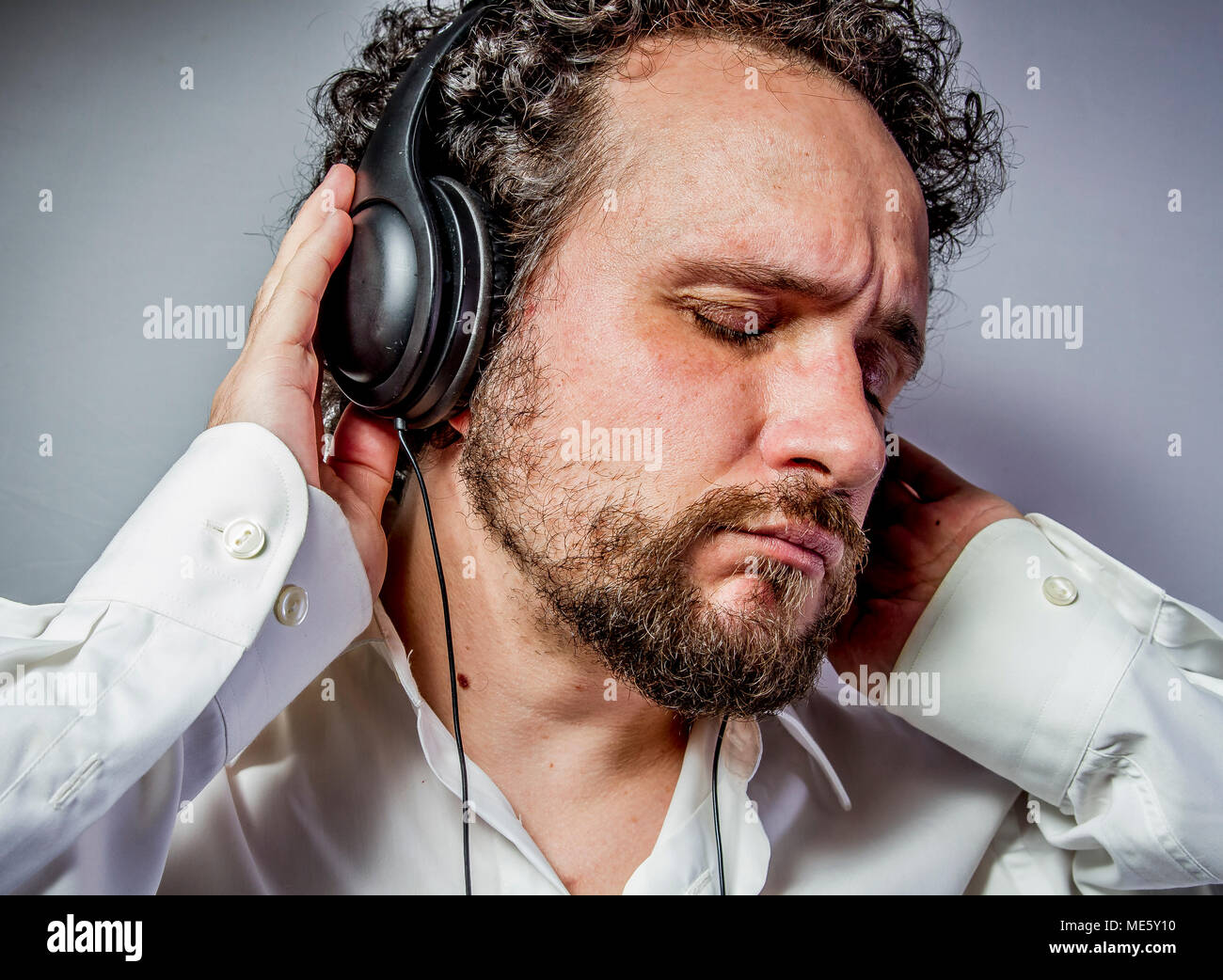 enjoy the music, man with intense expression, white shirt Stock Photo ...