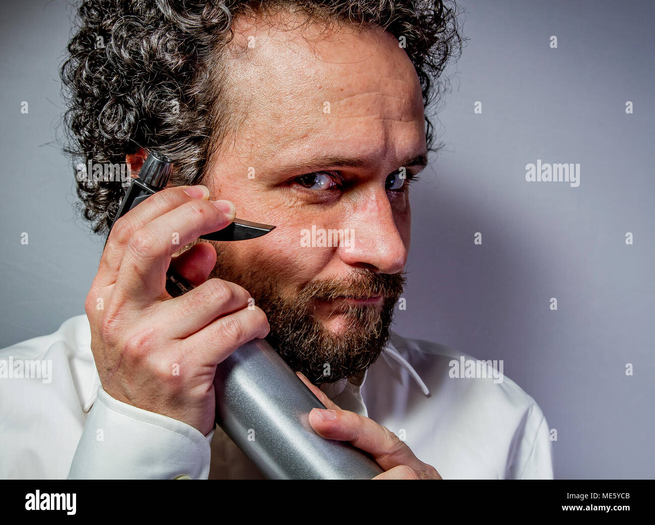 cleaning spray, man with intense expression, white shirt Stock Photo ...