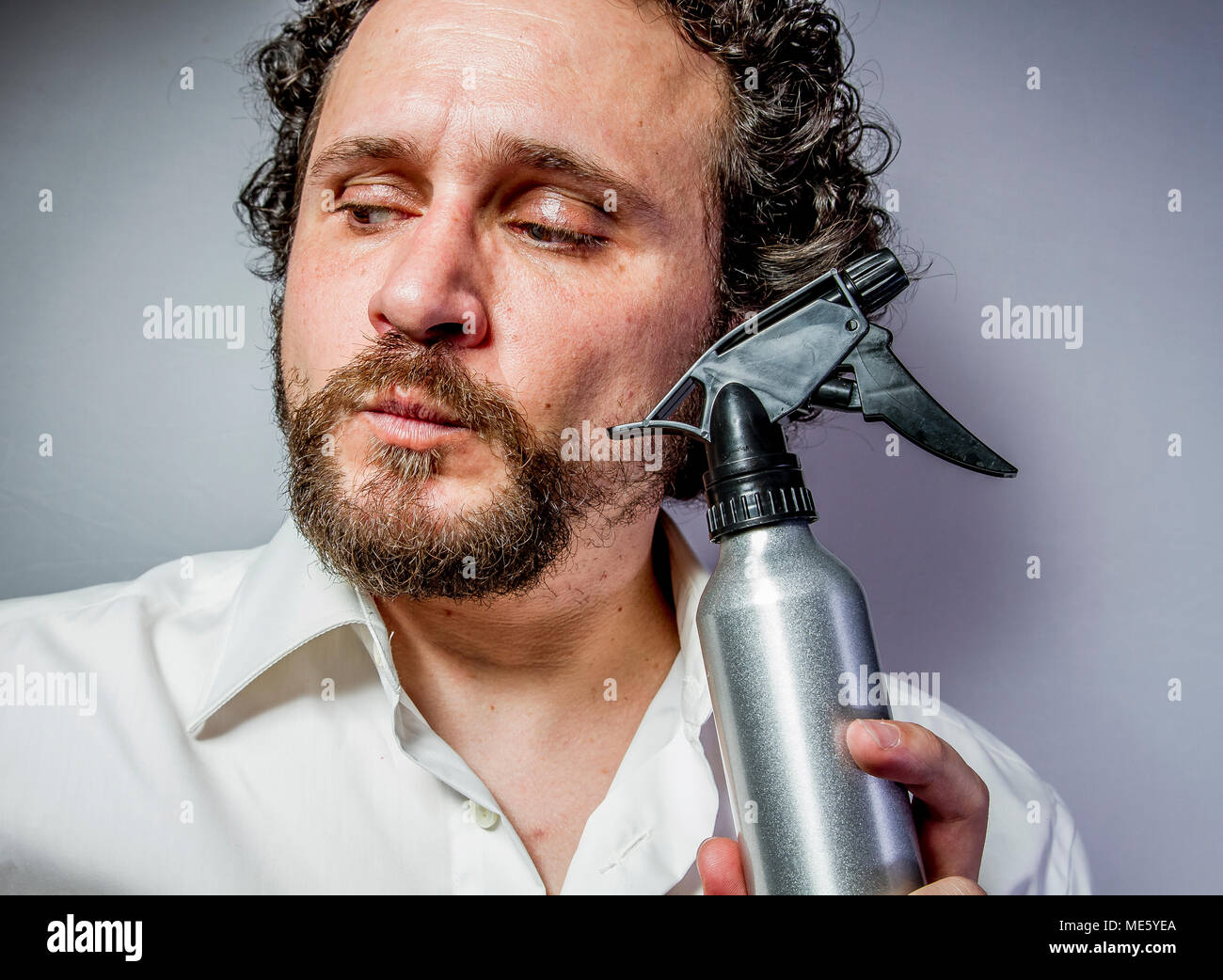 cleaning spray, man with intense expression, white shirt Stock Photo ...