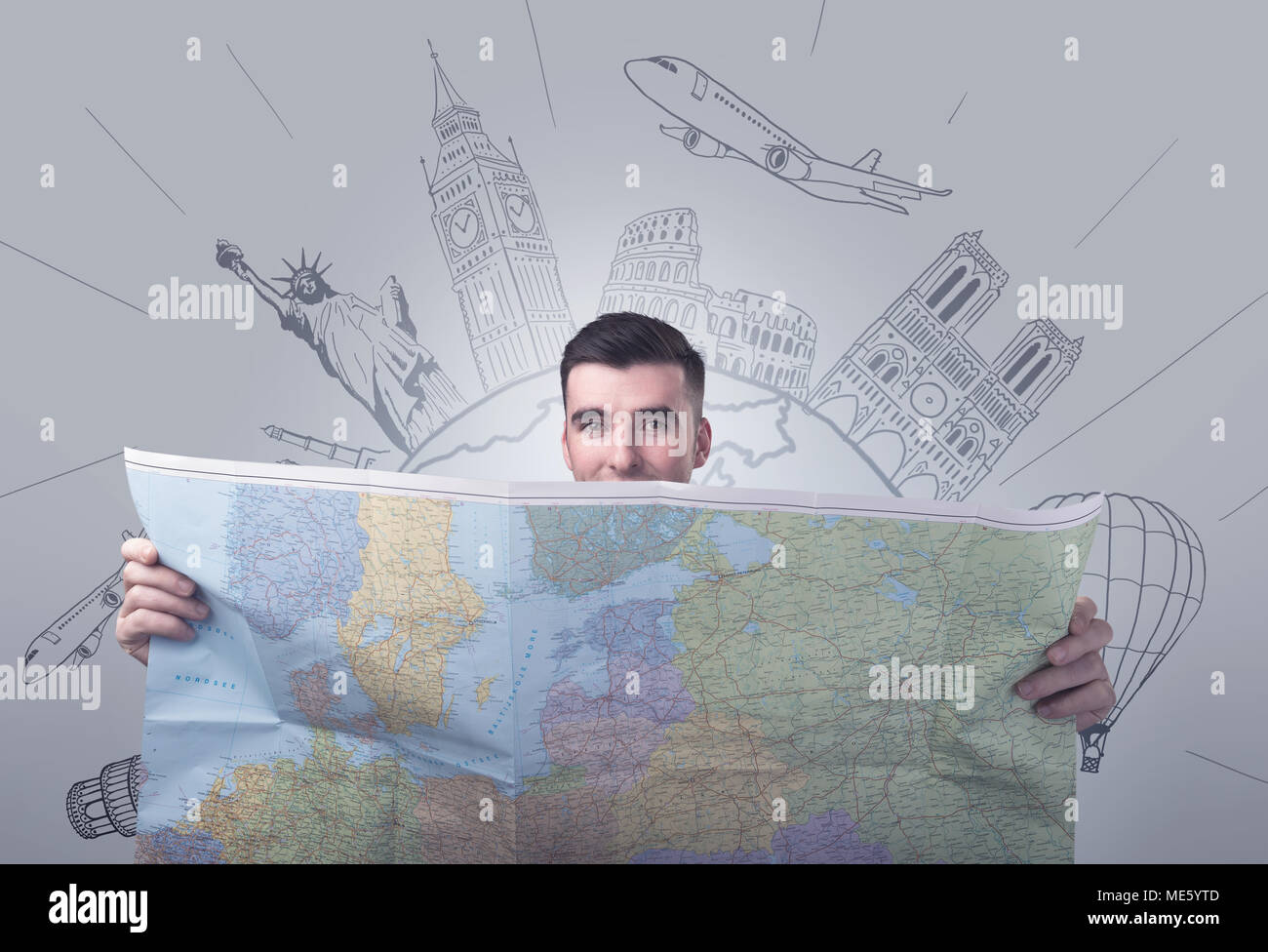 Handsome young man holding a map with famous sightseeing destinations ...
