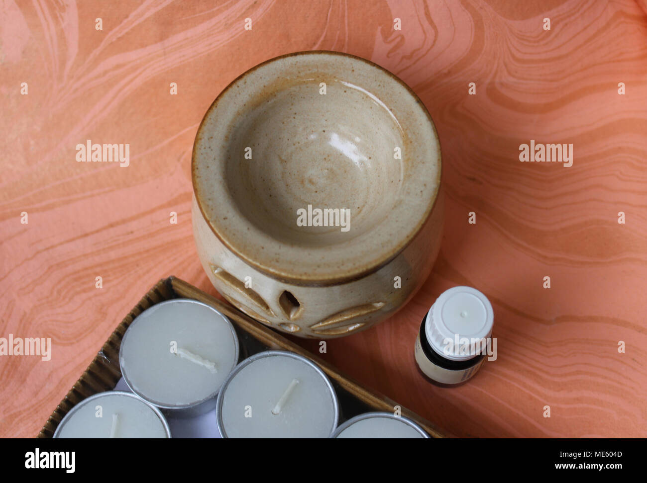 Ceramic diffuser, bottle of natural essential oil and packed tea lights ...