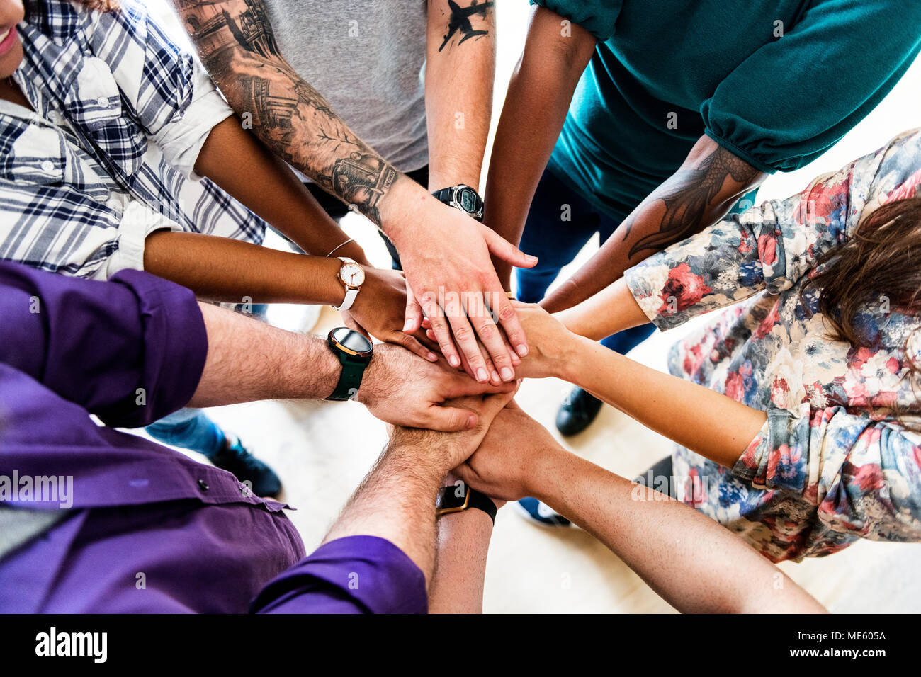 Group of diverse people joined hands together teamwork Stock Photo - Alamy