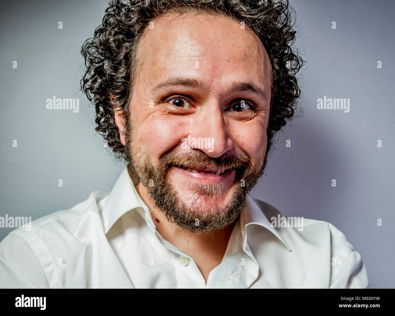 derision, man with intense expression, white shirt Stock Photo - Alamy