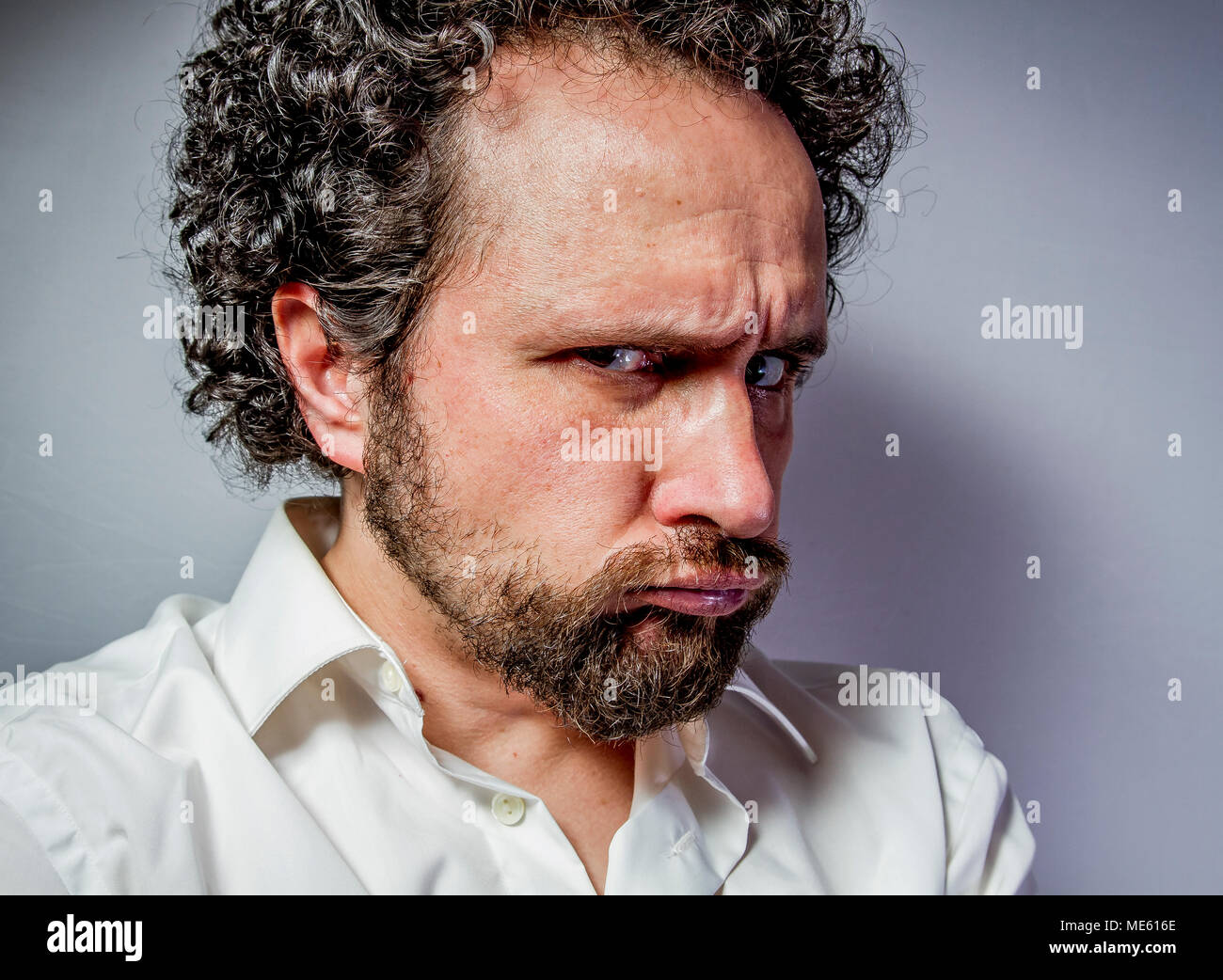 sad face, man with intense expression, white shirt Stock Photo - Alamy