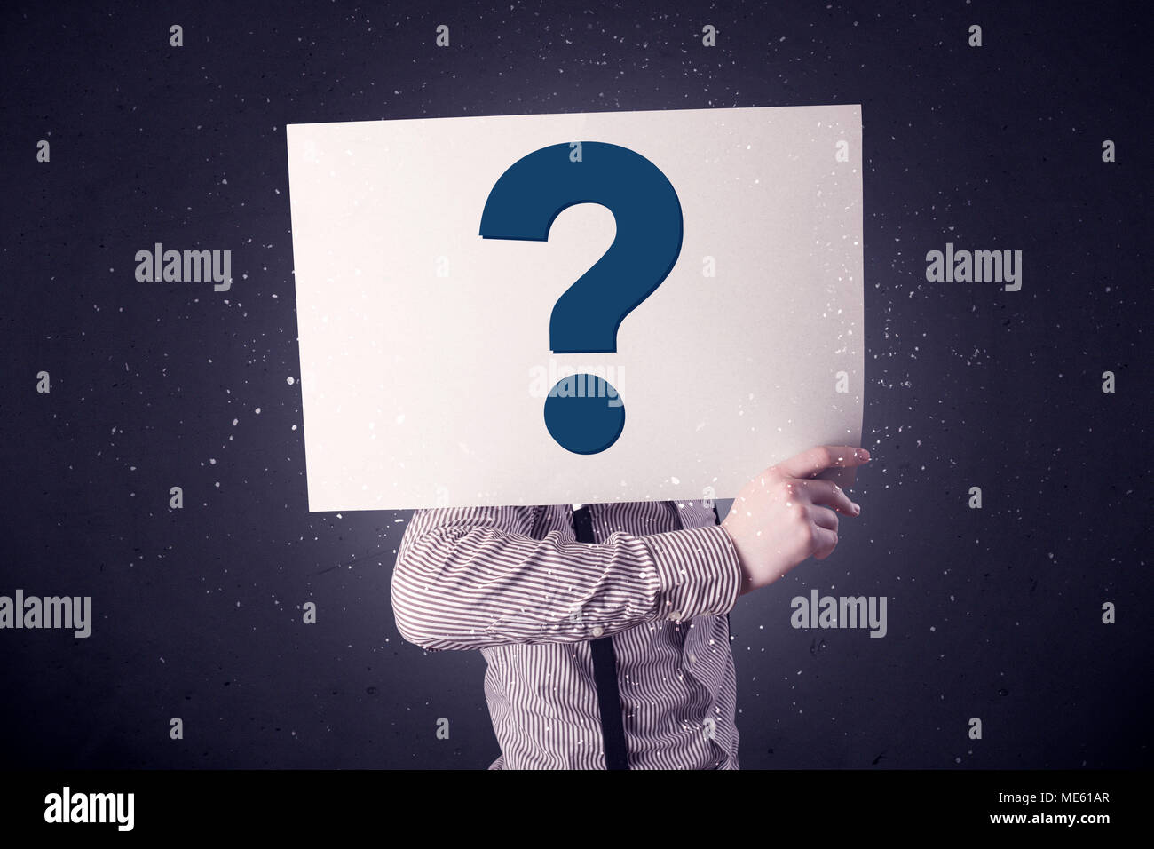 Young businessman hiding behind a question mark drawn on paper Stock ...