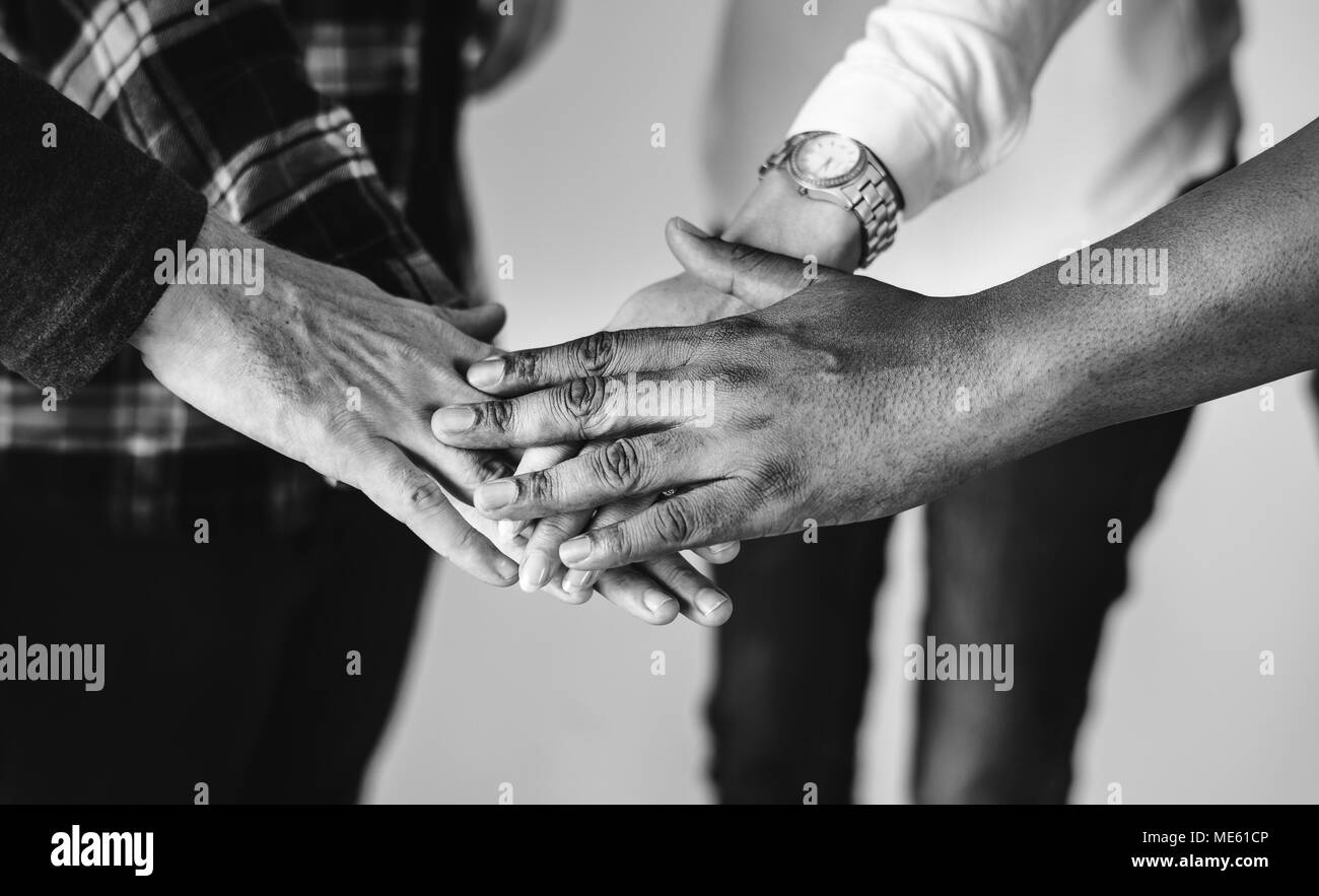 Diverse people joining hands together teamwork and community concept ...