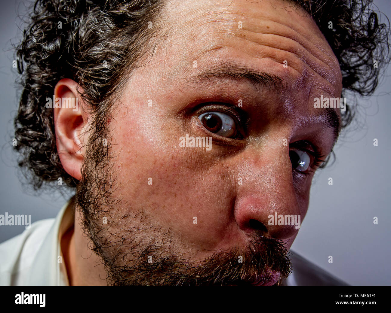 Fear, man with intense expression, white shirt Stock Photo - Alamy