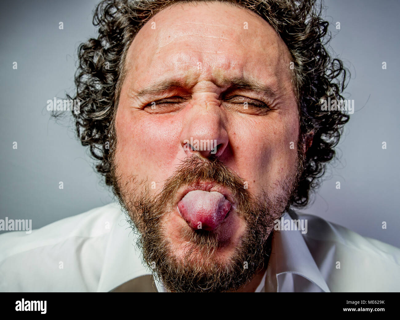 derision, man with intense expression, white shirt Stock Photo - Alamy