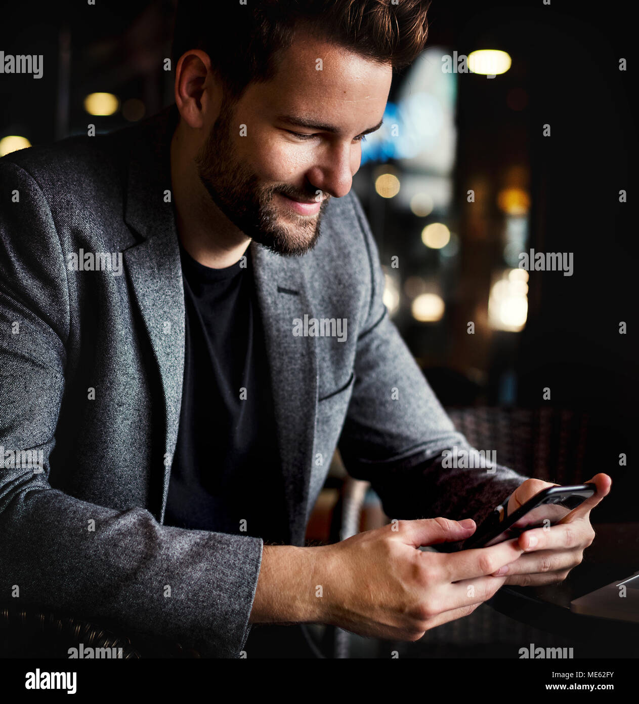 Man reading messages on his phone Stock Photo - Alamy
