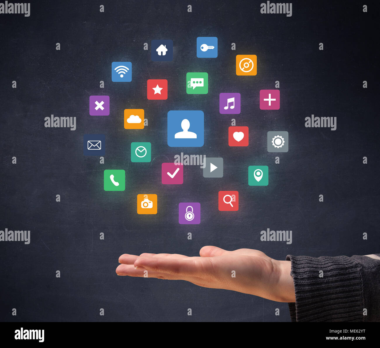 Colorful applications hovering over young hand Stock Photo - Alamy