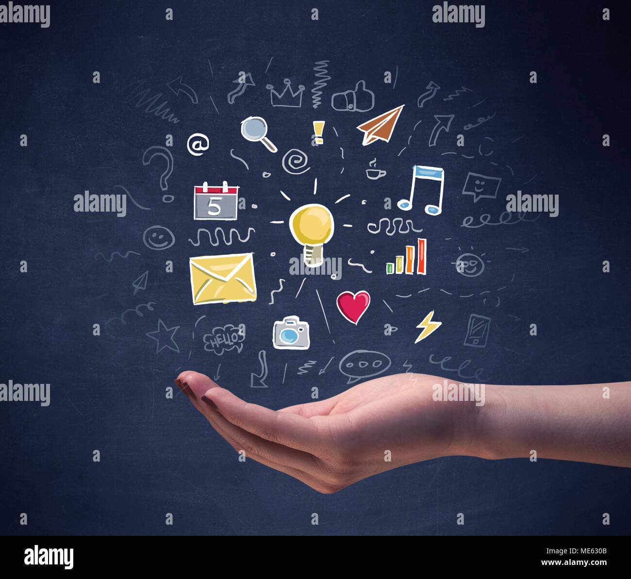 Colorful mixed media icons hovering over young hand Stock Photo - Alamy