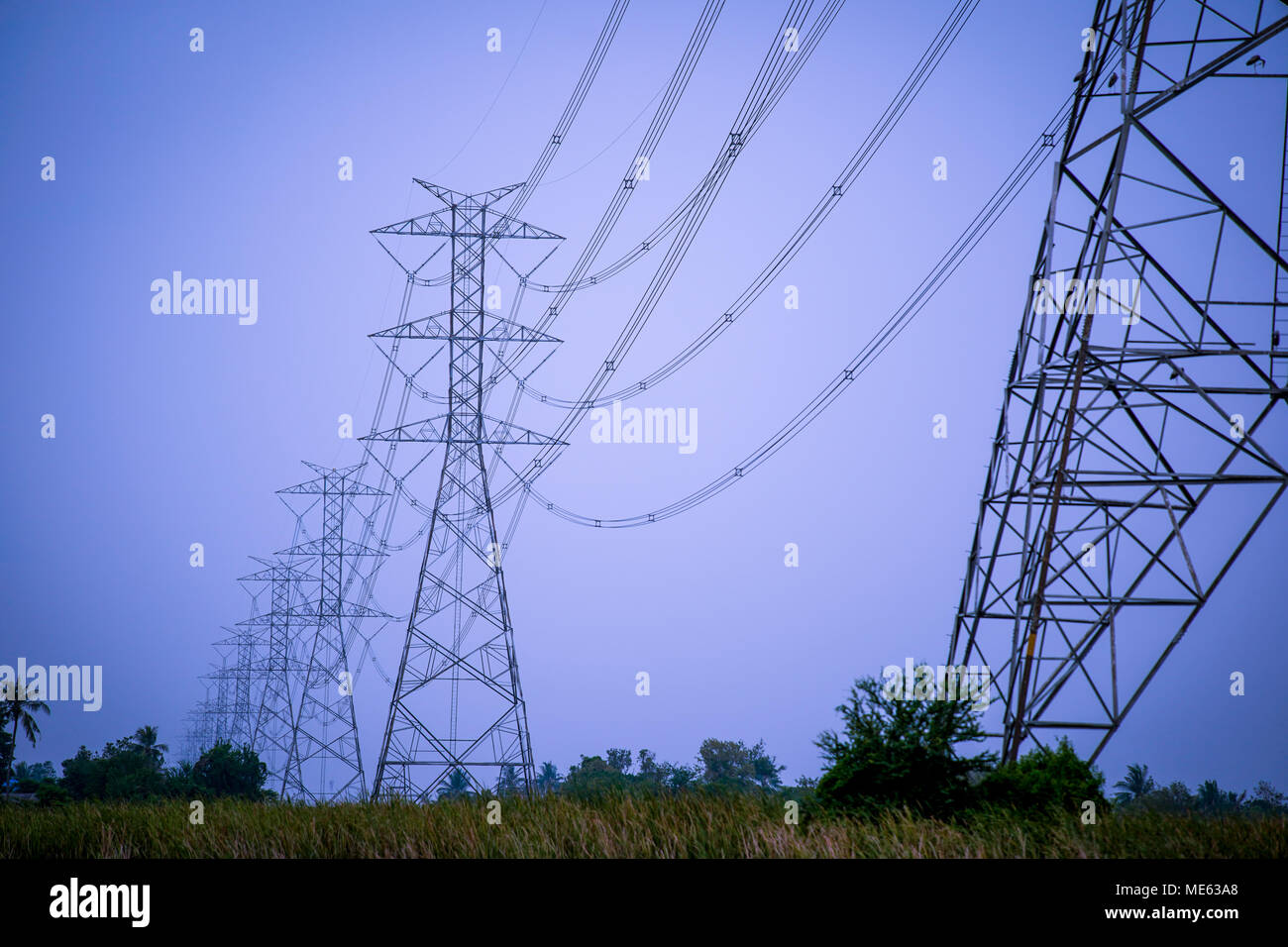 high voltage power lines during fiery sunset Stock Photo - Alamy
