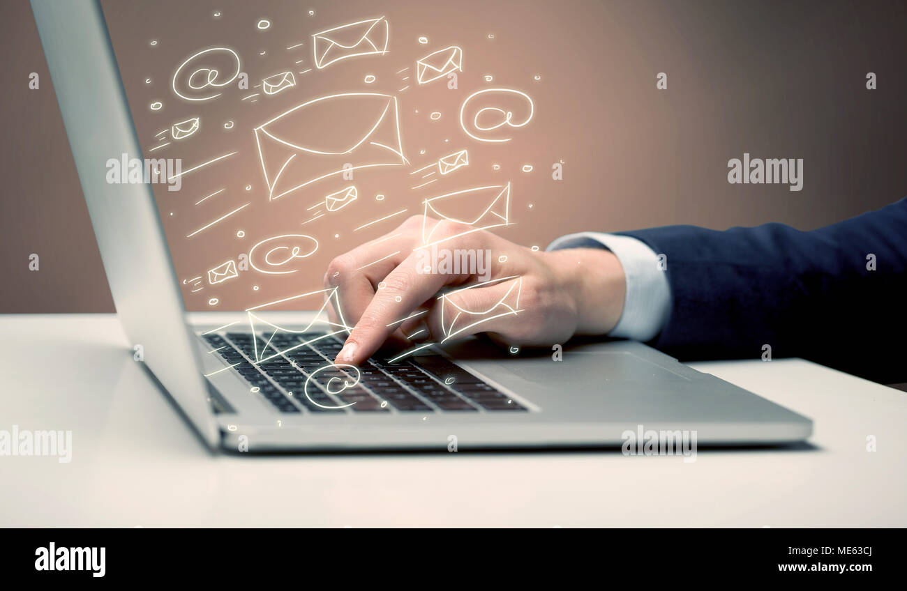 An office worker sending emails and communication with clients with the ...