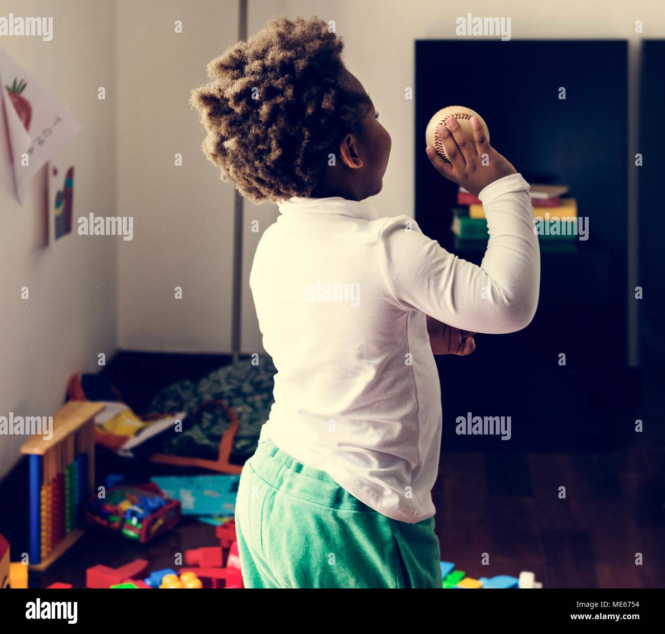 Black kid throwing baseball ball Stock Photo - Alamy
