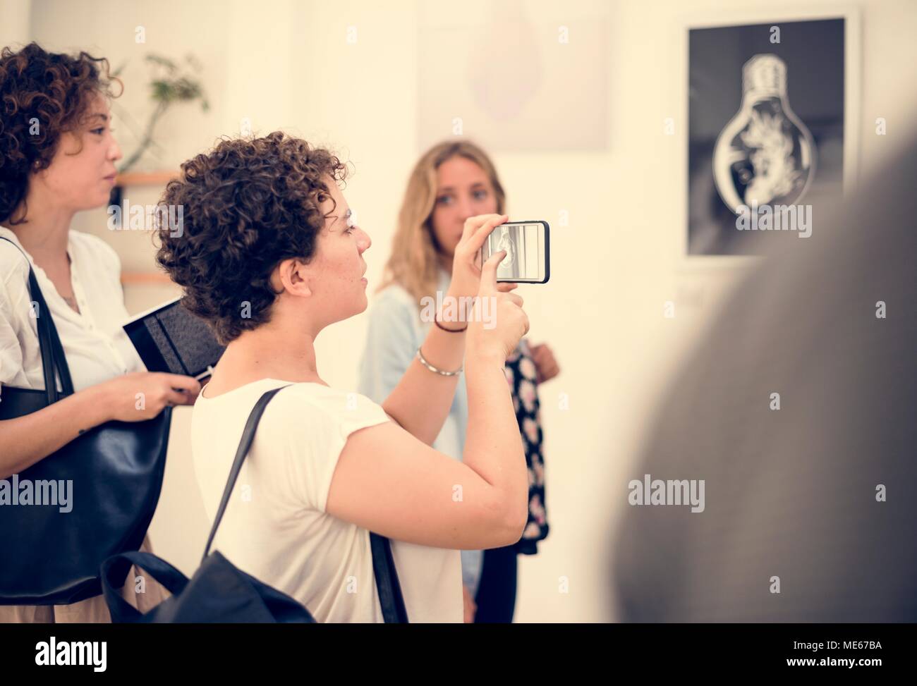 people checking out the exhibition Stock Photo - Alamy