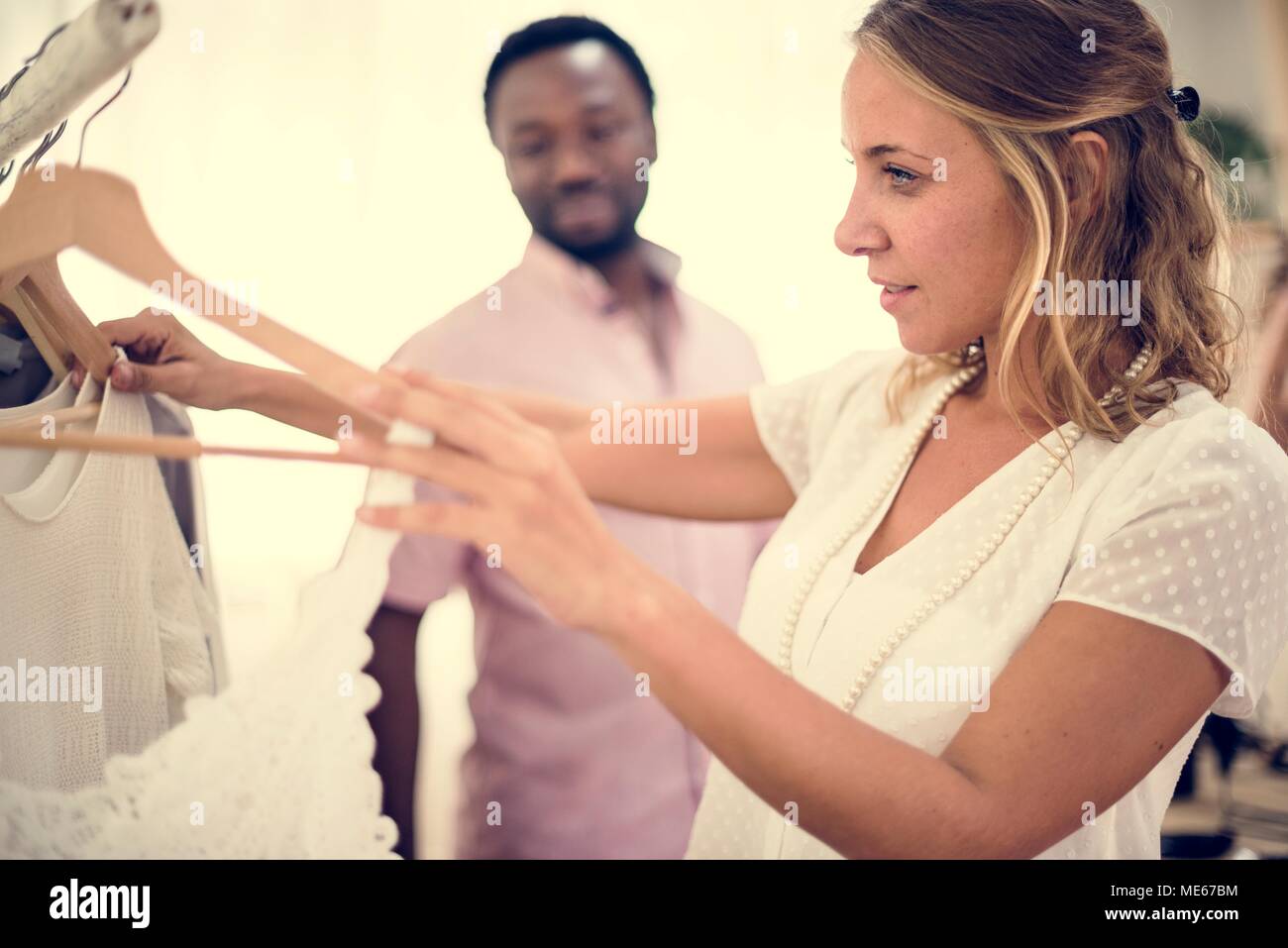People checking out clothes Stock Photo - Alamy