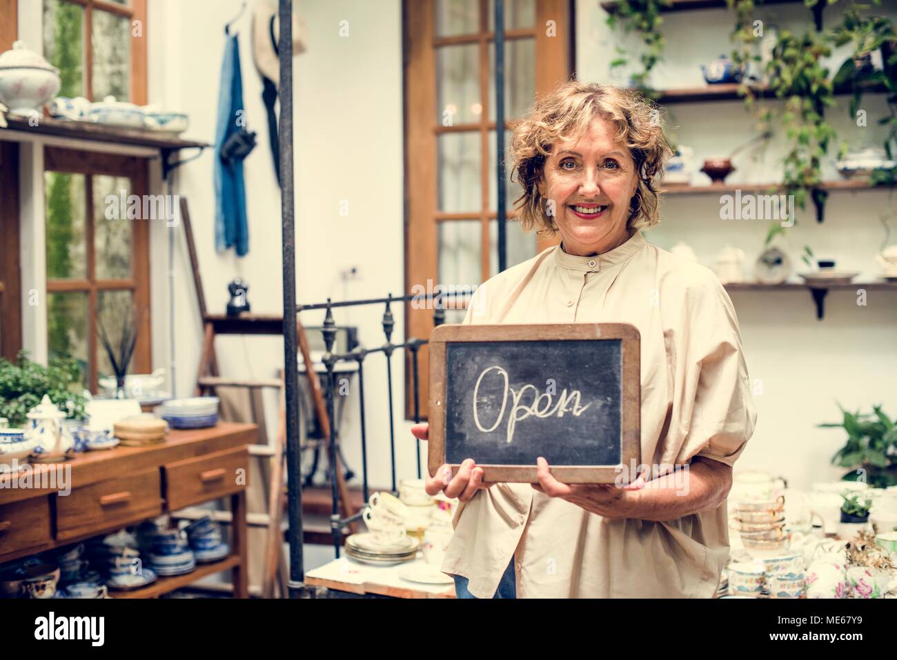 A woman owner with open sign Stock Photo - Alamy