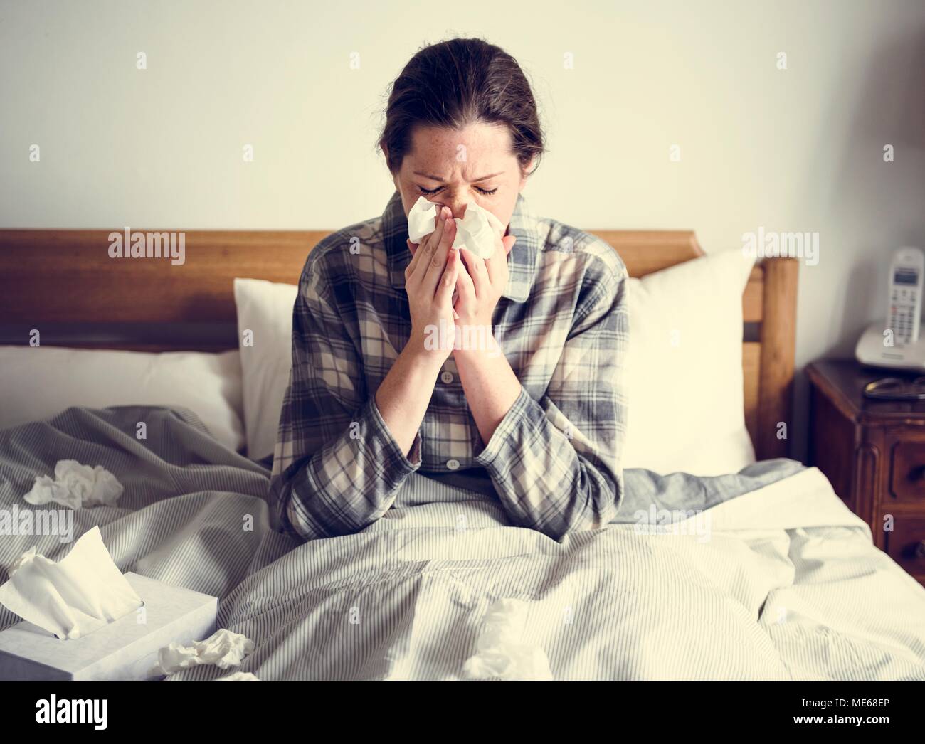 A woman suffering from flu in bed Stock Photo - Alamy