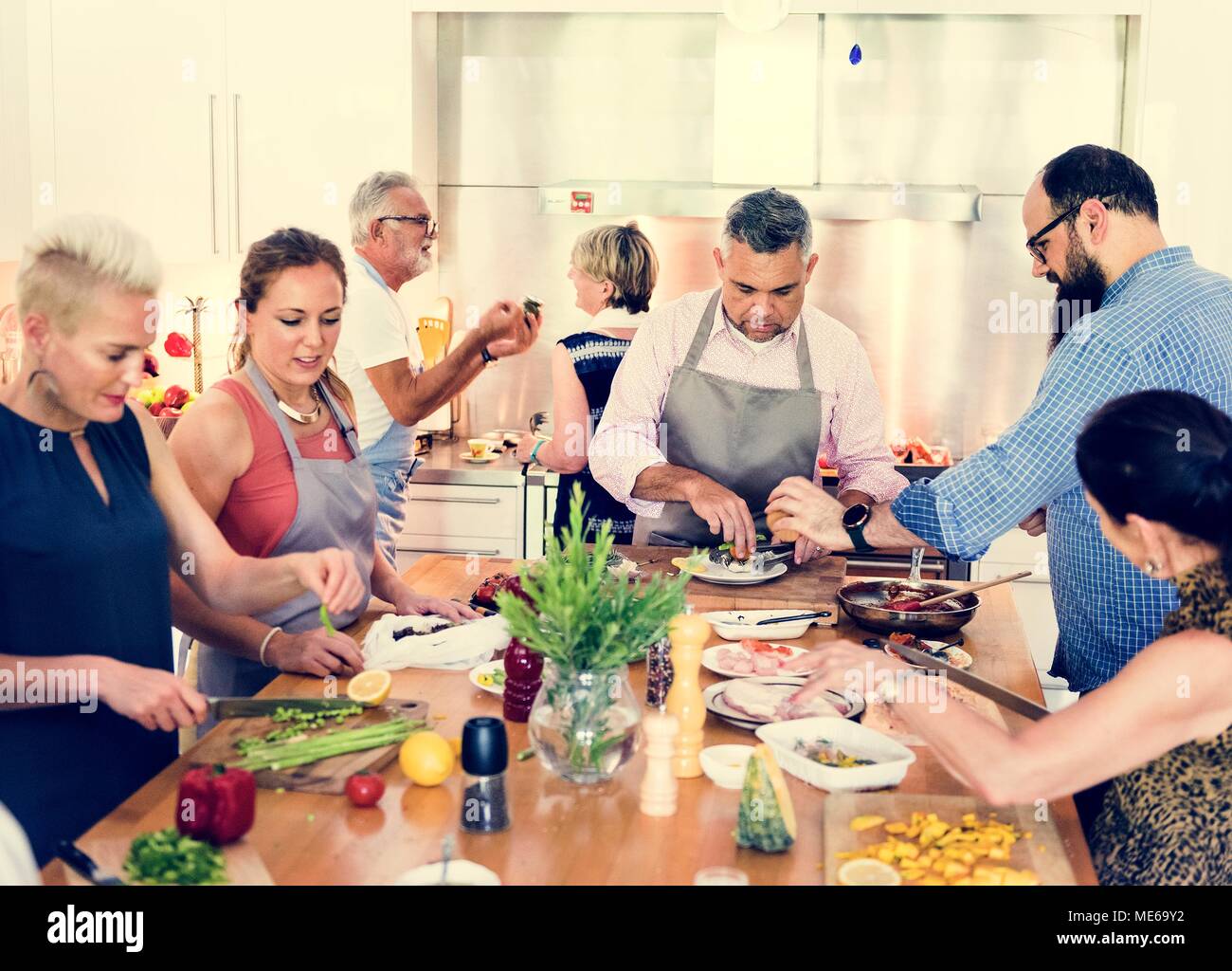 Friends prepare meal in hi-res stock photography and images - Alamy