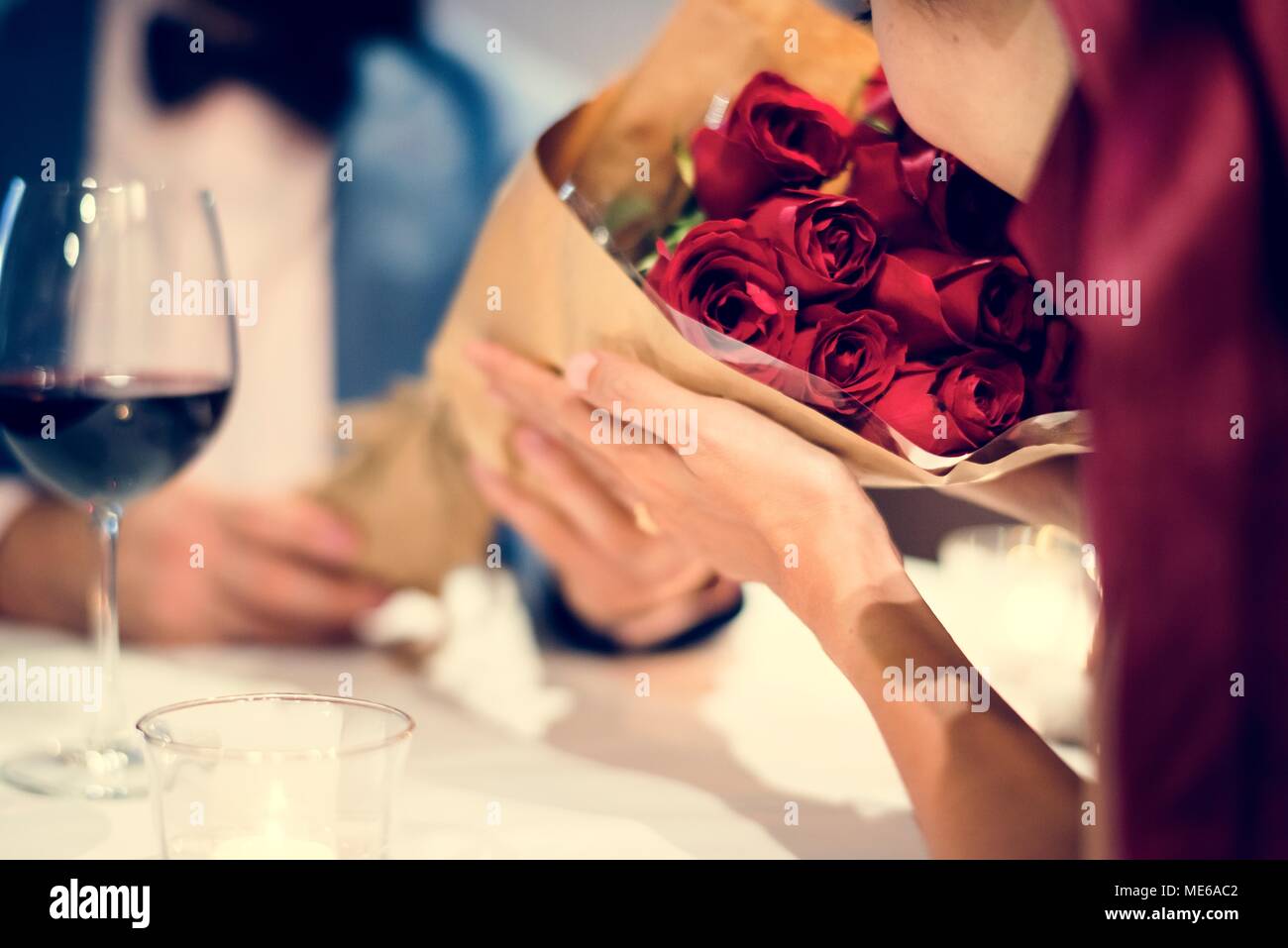 Man giving red rose bouquet Stock Photo - Alamy