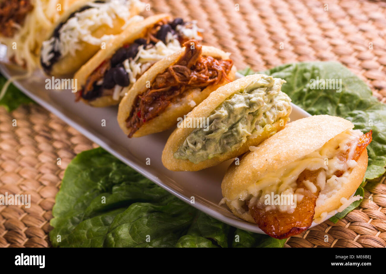 Different types of arepas, meat, black beans, cheese, fried plantain ...