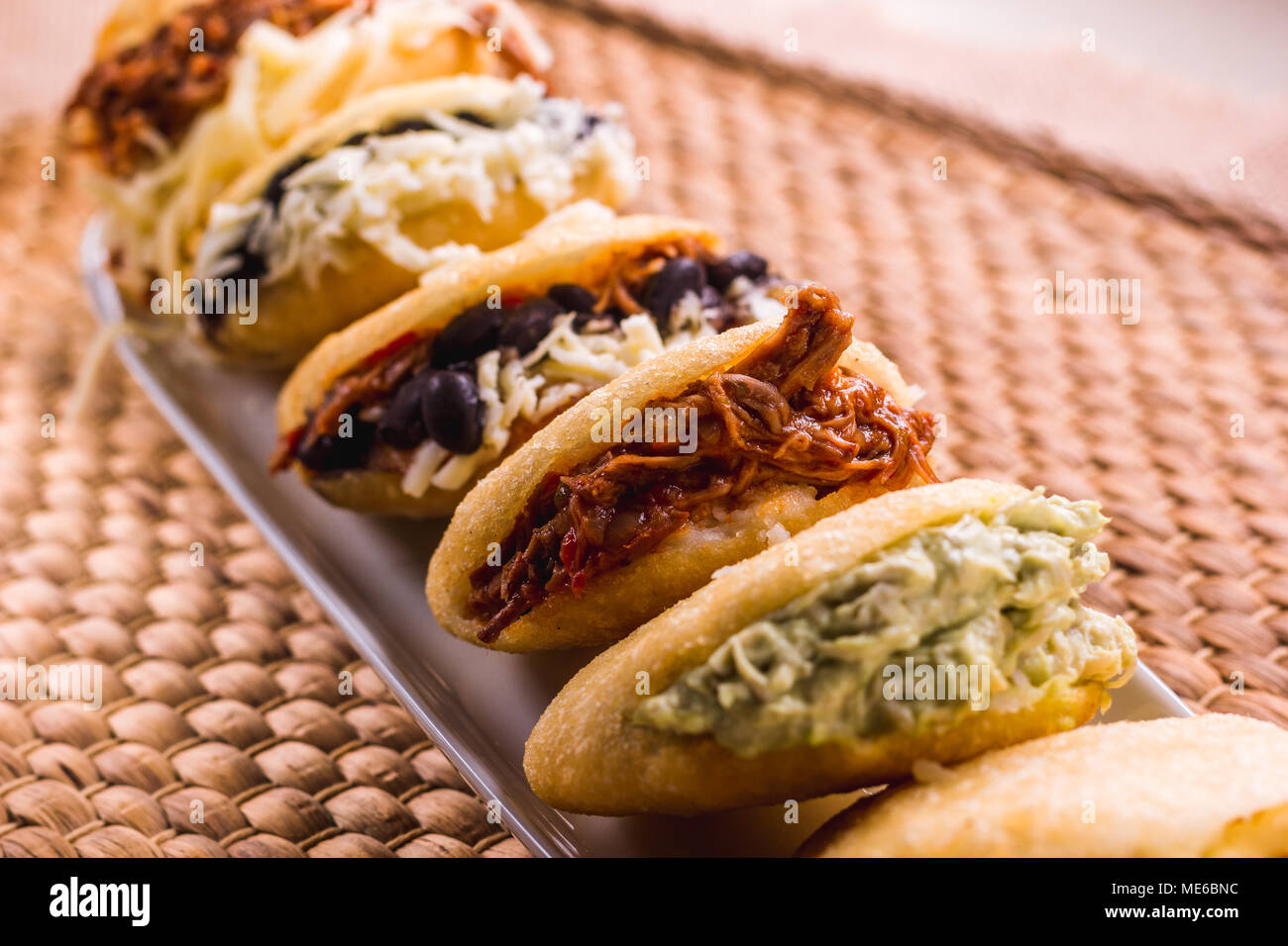 Different types of arepas, meat, black beans, cheese, fried plantain ...