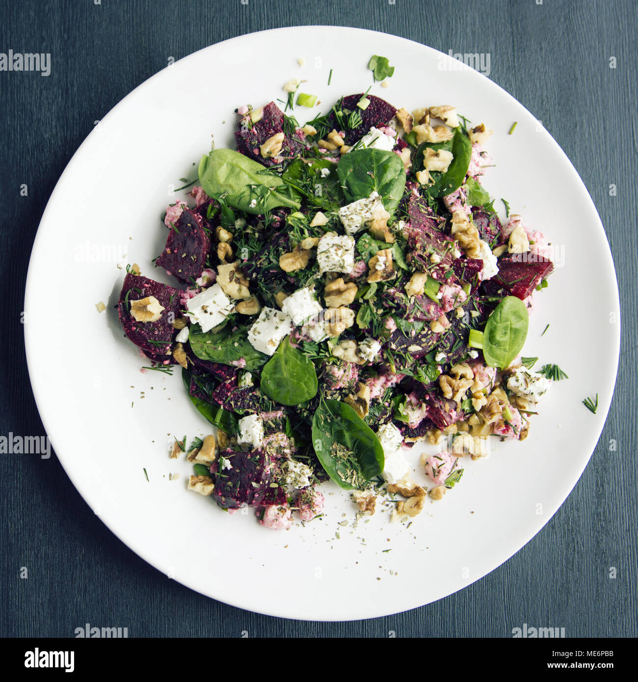 Beetroot salad with cottage cheese, baby spinach and walnuts. European ...