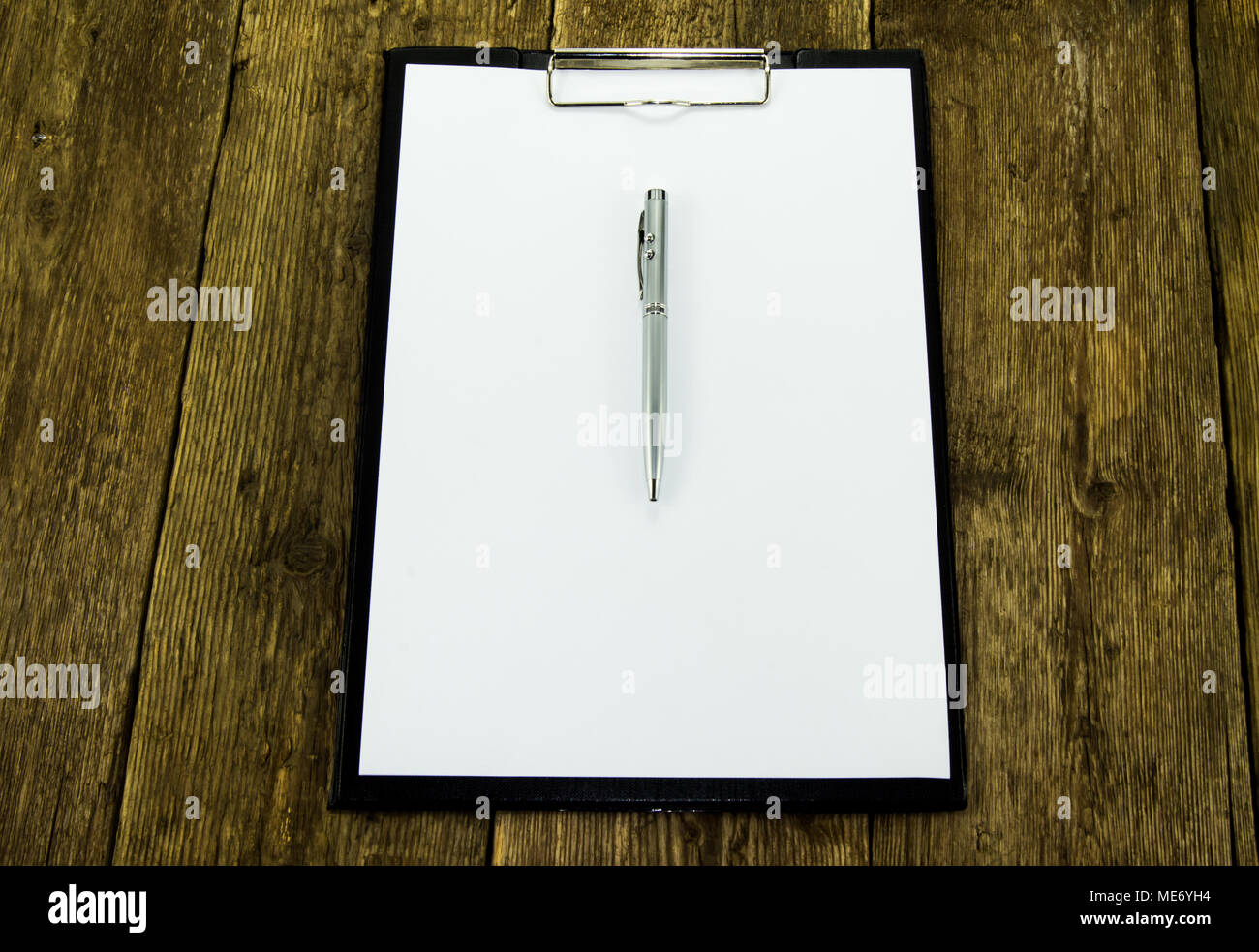White paper and pen on wood background. For your commercial and ...