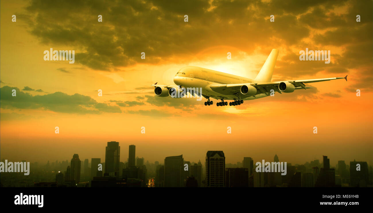 air plane flying over sky scraper and sun set sky background Stock ...