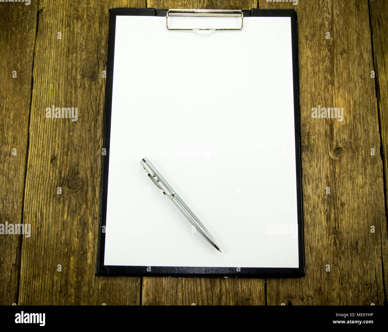 White paper and pen on wood background. For your commercial and ...