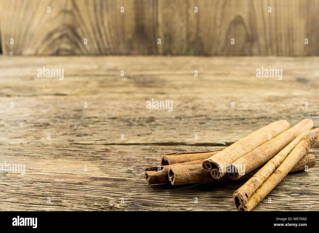 Close up of cinnamon sticks on rustic wood . For your commercial and ...
