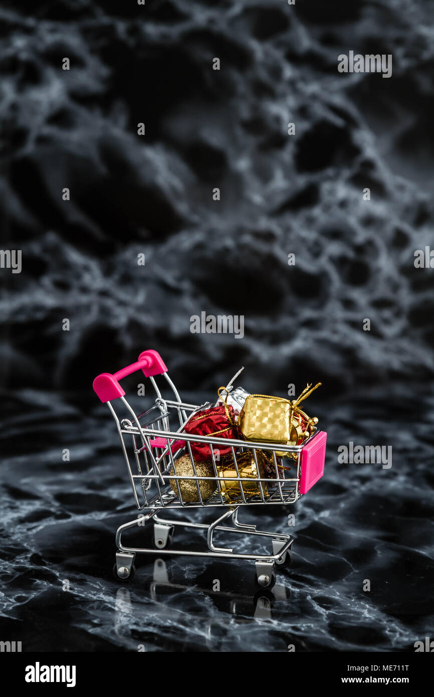 Miniature shopping charts on black marble background Stock Photo - Alamy