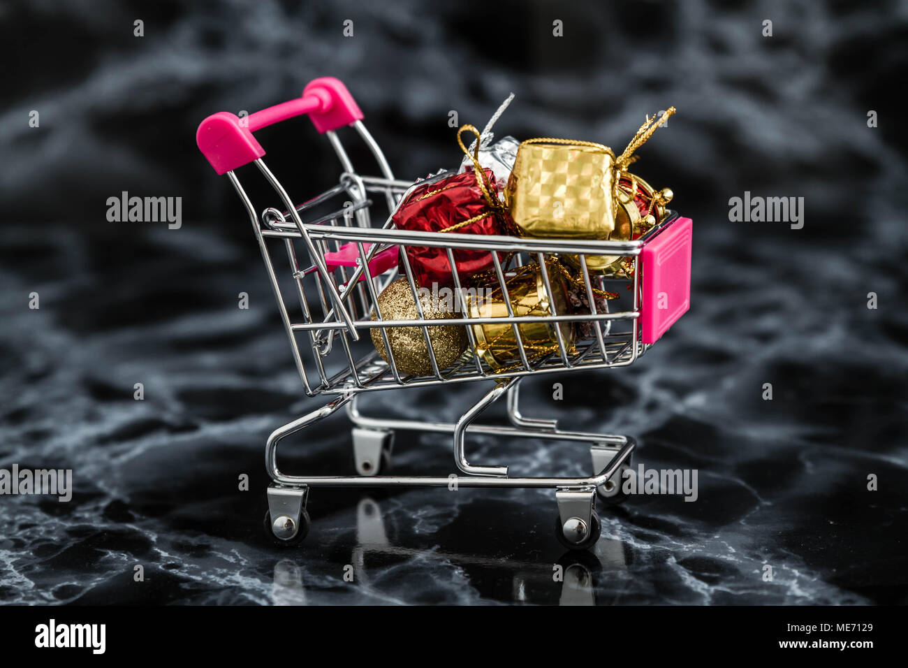 Miniature shopping charts on black marble background Stock Photo - Alamy