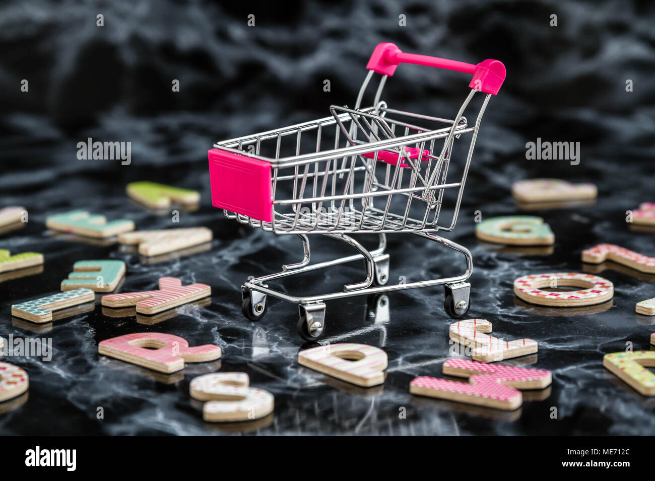 Miniature shopping charts on black marble background Stock Photo - Alamy