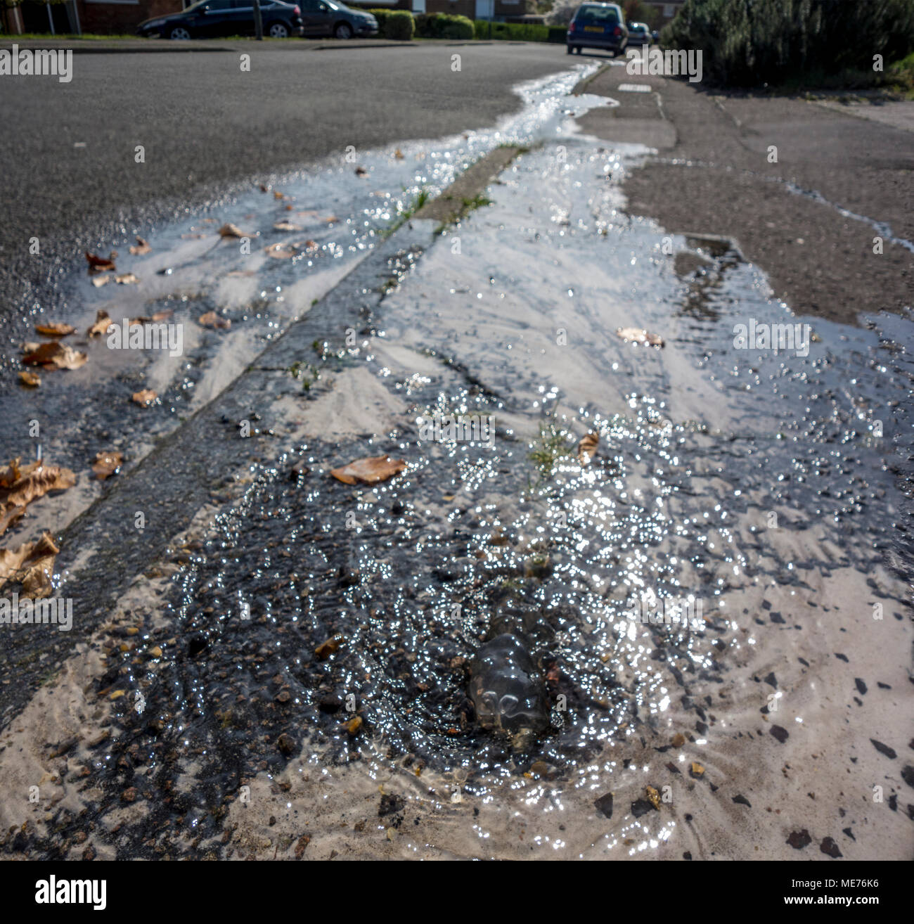 Water leak street Stock Photo - Alamy