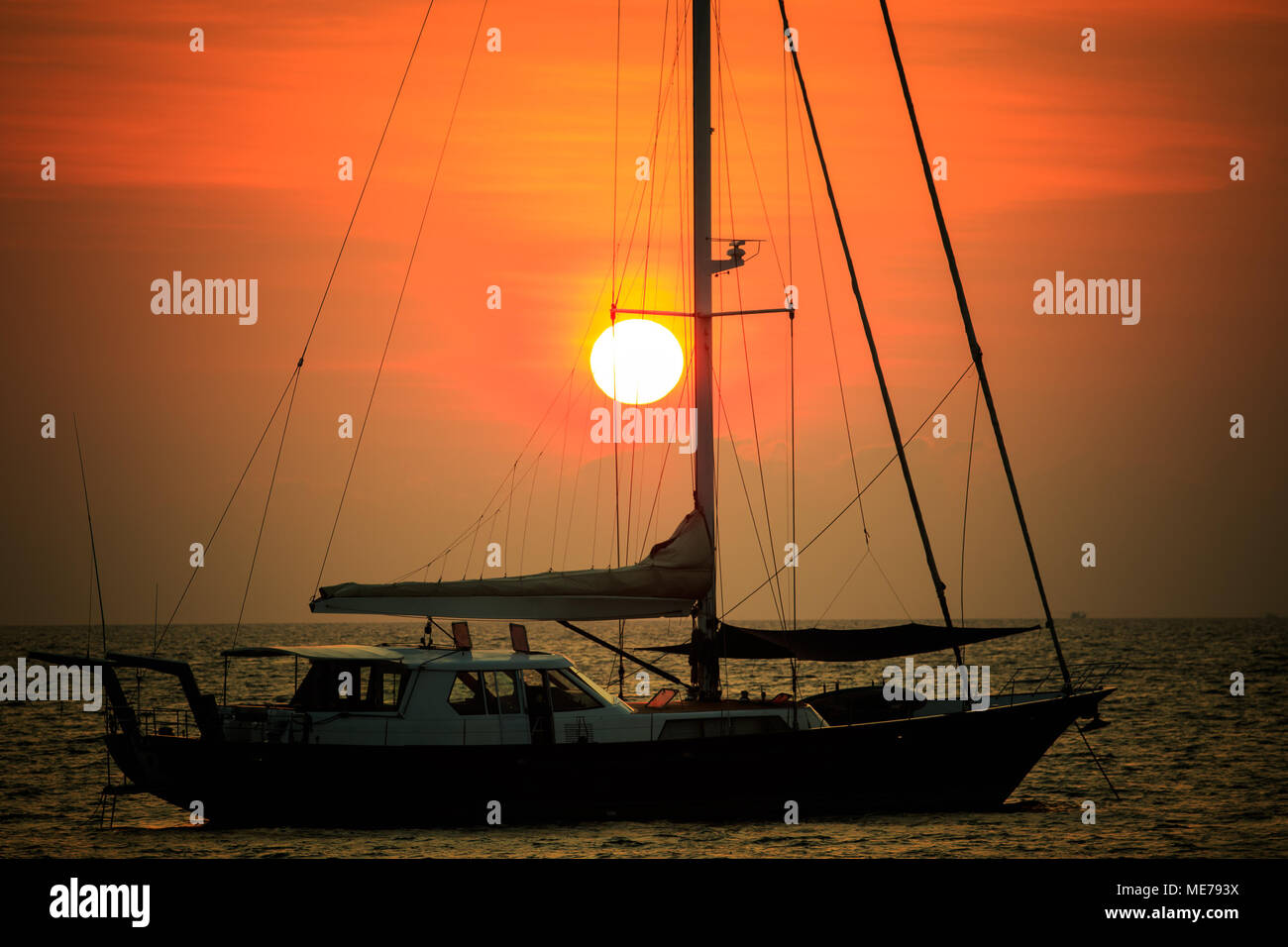 beautiful natural scenic of sun set behind sailing boat Stock Photo - Alamy