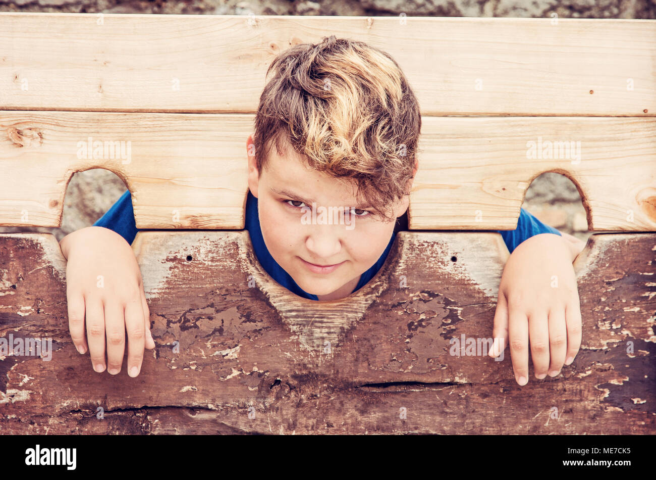 Young caucasian boy in medieval pillory. Misery theme. Punishment ...